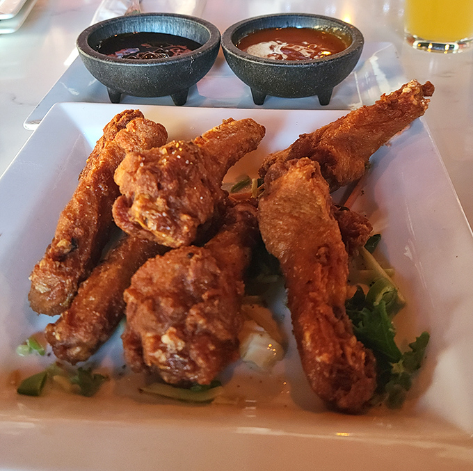 These aren't just wings; they're crispy ambassadors of flavor served with dipping sauces in adorable cauldron-like vessels. Finger-licking mandatory.