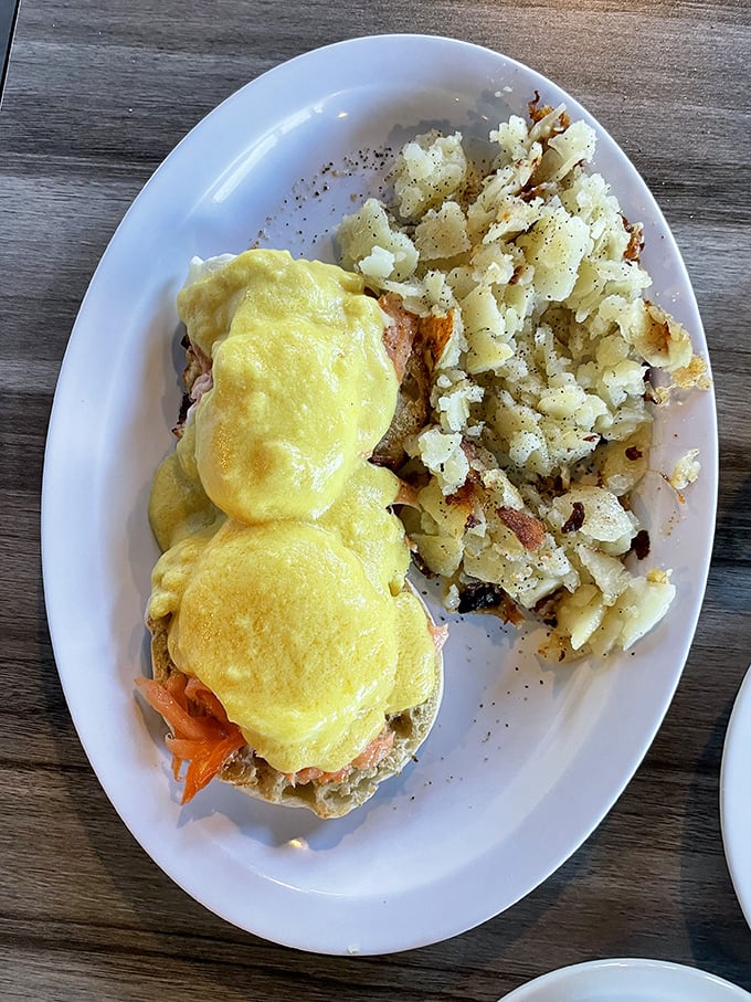 Eggs Benedict done right is breakfast's highest art form. This plate, with its sunshine-yellow hollandaise and crispy potatoes, is frameable.