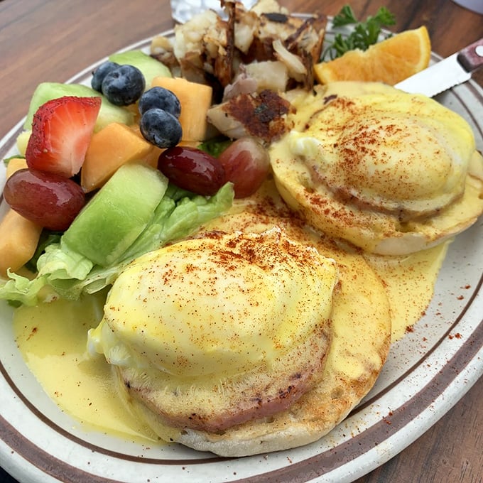 Eggs Benedict that would make a cardiologist wince and a food lover weep. Hollandaise sauce cascading like a yellow waterfall of happiness.