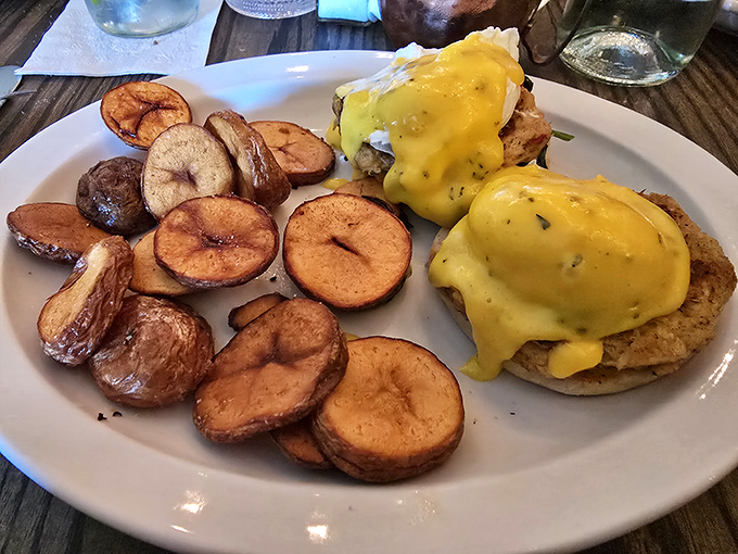 Eggs Benedict: where breakfast meets black-tie optional. Those home fries look like they've been practicing their crispiness for decades.