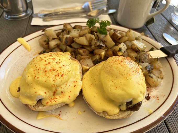 Eggs Benedict perfection &ndash; golden hollandaise cascading over English muffins like a sunrise over Lake Tahoe.