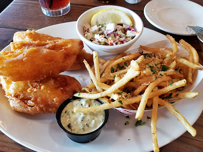 Fish and chips this golden should come with sunglasses. The crispy batter crackles with each bite, revealing flaky white fish beneath.