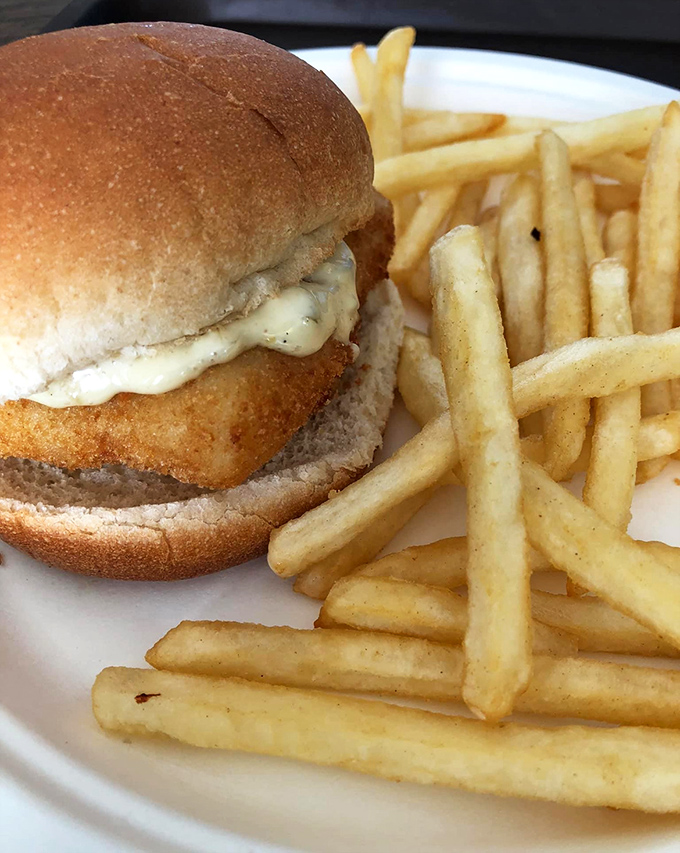 The famous fish sandwich in all its glory, accompanied by perfectly crisp fries. This is what seafood dreams are made of&mdash;simple, honest, and utterly delicious.