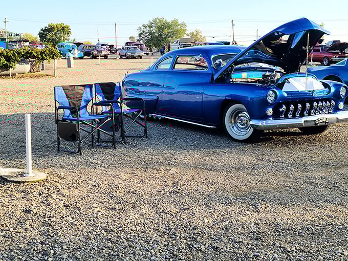 The perfect drive-in setup: vintage wheels, folding chairs, and conversations that pause only for the best movie moments.