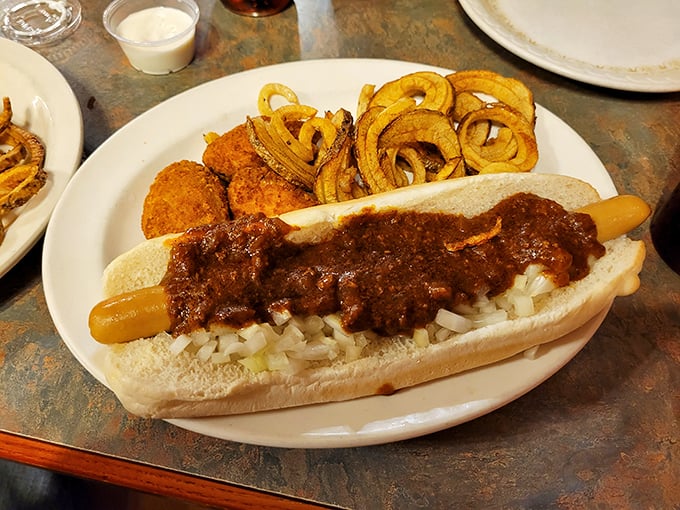 The footlong Coney with diced onions and that legendary sauce, served with a side of golden onion rings. A meal that satisfies both hunger and nostalgia simultaneously.