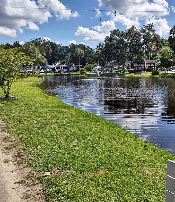 A serene pond reflects Florida's famously cloud-dotted skies, offering RV residents a daily dose of tranquility with their morning coffee.