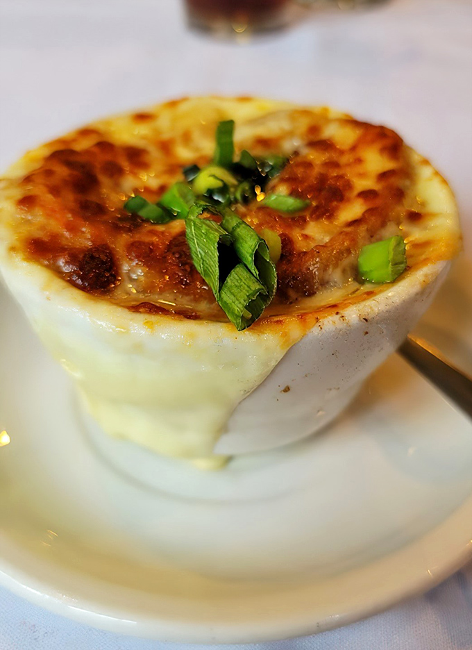 French onion soup that's worth the inevitable cheese pull photo-op. That golden, bubbling top is hiding a savory treasure underneath.