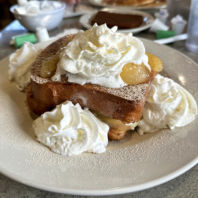 French toast that's having an identity crisis as dessert. With whipped cream islands floating in a sea of sweet syrup&mdash;breakfast nirvana achieved.