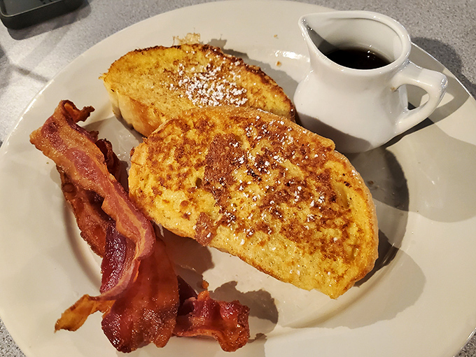 French toast that's achieved that magical golden-brown perfection, with bacon that's exactly how bacon should be—no further explanation needed.
