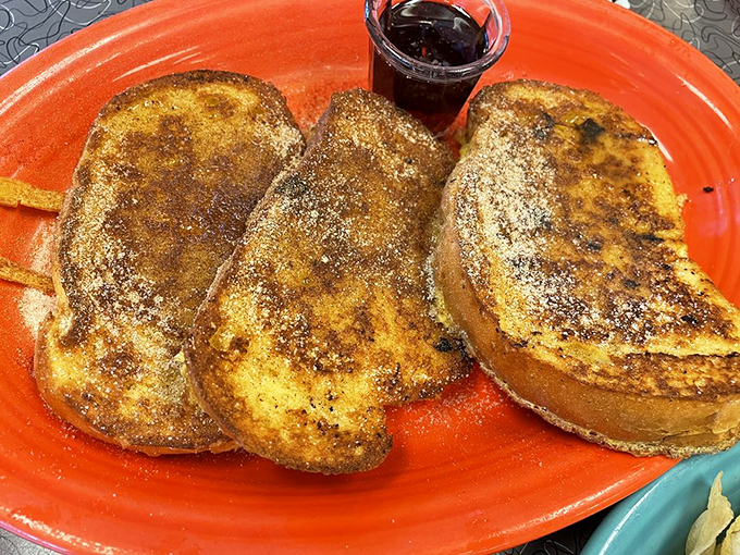 French toast that's crossed the line from breakfast to dessert, dusted with cinnamon and powdered sugar. Your pancreas is sending hate mail, but your soul is sending thank-you notes.