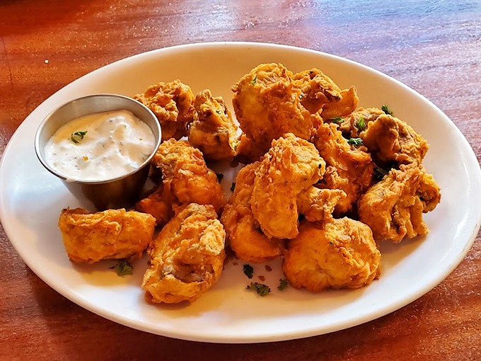 These crispy mushrooms arrive like edible clouds, proving that vegetables can be just as indulgent as dessert.