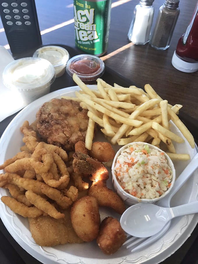 The seafood combo platter &ndash; where indecision becomes a virtue. Golden-fried treasures from the sea alongside crispy fries and homestyle coleslaw.