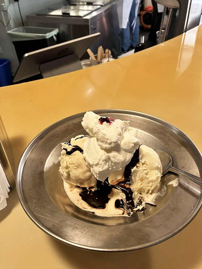 Some sundaes whisper. This one sings opera. Hot fudge cascading over vanilla ice cream like chocolate lava finding its delicious destiny.