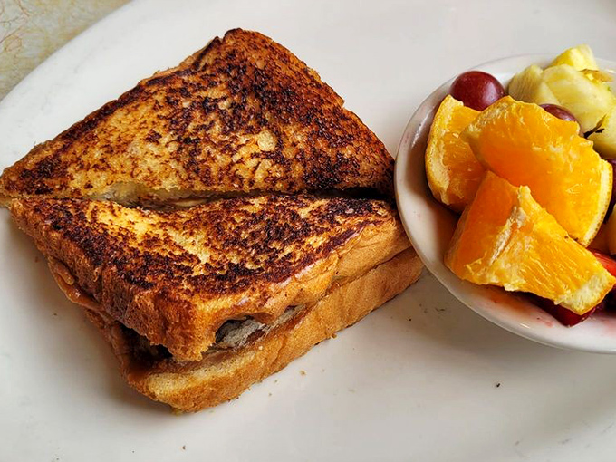 This isn't just grilled cheese&mdash;it's a golden-brown masterpiece with the perfect fruit sidekick. Comfort food that graduated with honors. 