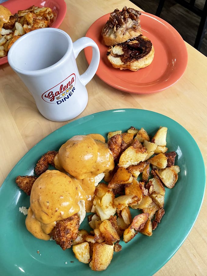 Behold the breakfast of champions: eggs smothered in cheese sauce alongside home fries that achieve the perfect crisp-to-tender ratio. The diner mug completes this morning masterpiece.