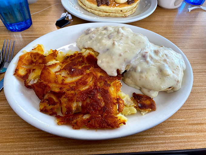 Comfort on a plate: crispy home fries alongside creamy gravy-smothered goodness. Some mornings call for savory indulgence that hugs your soul.
