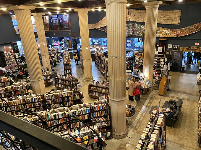 Towering columns and endless shelves create a cathedral of literature where book worshippers gather to find their next sacred text.