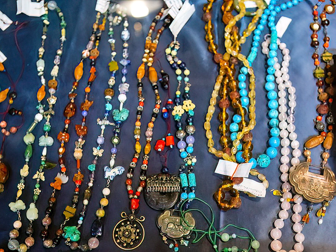 A kaleidoscope of vintage beads and pendants awaiting their second act—jewelry that carries the patina of previous adventures.