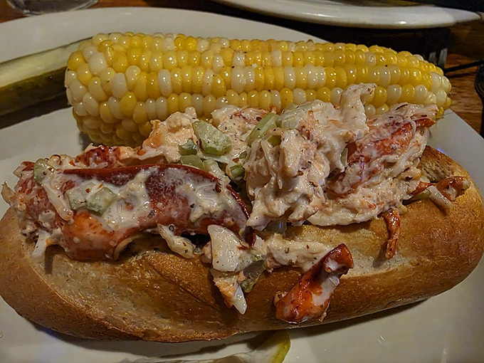 This isn't just a lobster roll—it's summer vacation stuffed into bread. Sweet lobster meat mingles with creamy dressing alongside golden corn on the cob for the perfect coastal pairing.