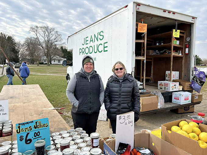 Farm-fresh finds! Jean's Produce brings local bounty to market shoppers, with homemade jams and bright yellow lemons brightening a cloudy Michigan morning. 