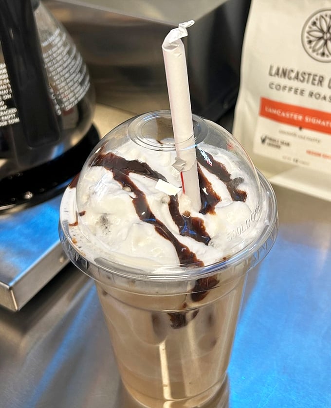This isn't just a milkshake, it's a drizzled masterpiece of childhood dreams. The chocolate sauce zigzagging down the sides is pure edible art.