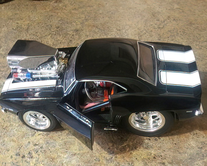 The collectibles section: where one person's decluttered shelf becomes another's prized display. This miniature muscle car represents thrifting's greatest joy&mdash;the unexpected find.