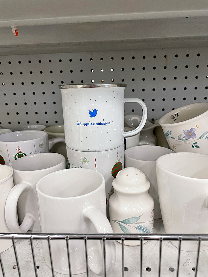 Someone's Twitter mug awaits its next chapter, nestled among ceramic companions with stories to tell.