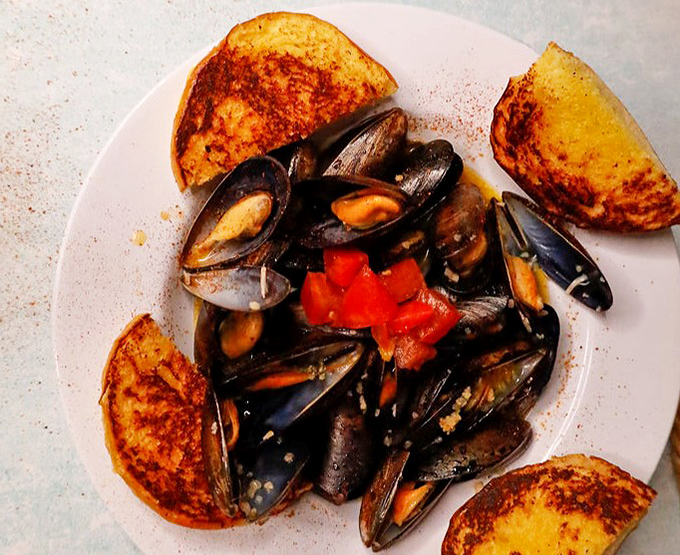 Behold the star of the show: plump mussels nestled with toasted bread, ready to transport your taste buds.