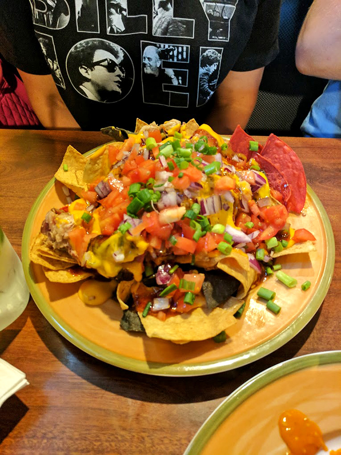 Nachos that require a strategy meeting before eating. Layer upon colorful layer of toppings that make sharing both necessary and slightly heartbreaking.