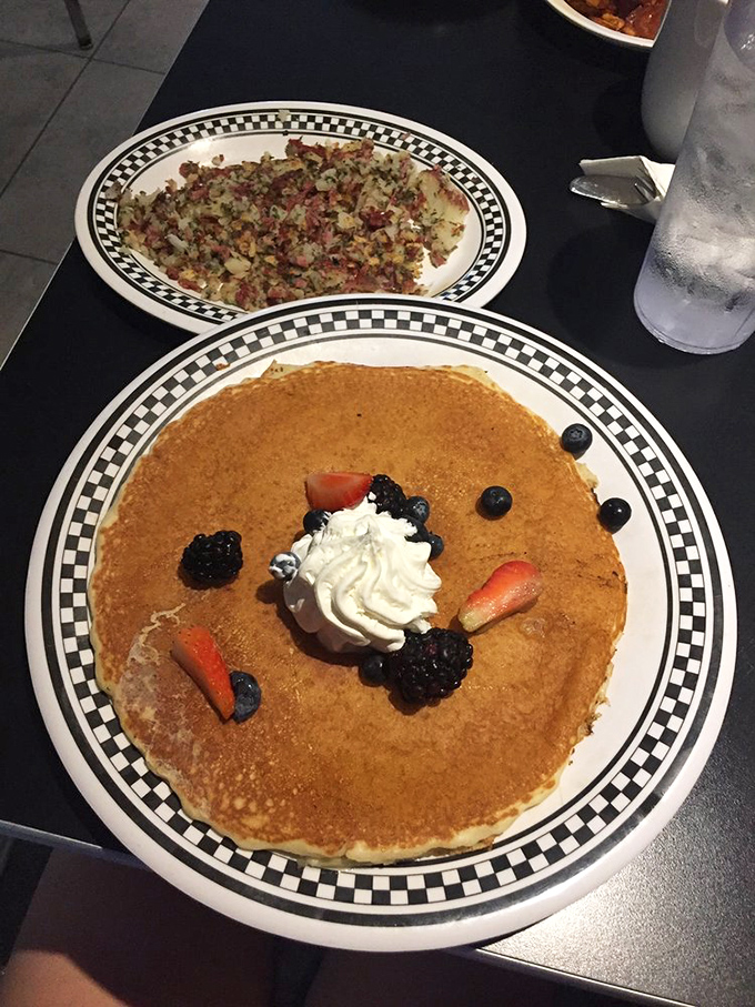 Pancake perfection meets berry bliss! This golden disc topped with fresh berries and whipped cream is what breakfast dreams are made of.
