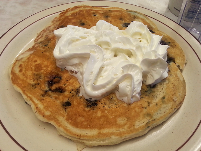 Pancakes crowned with whipped cream clouds – because sometimes breakfast deserves to feel like dessert.