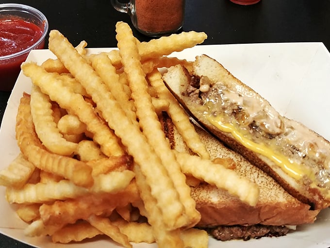 The patty melt arrives like a cheesy, grilled symphony, those crinkle-cut fries playing backup to the main attraction.
