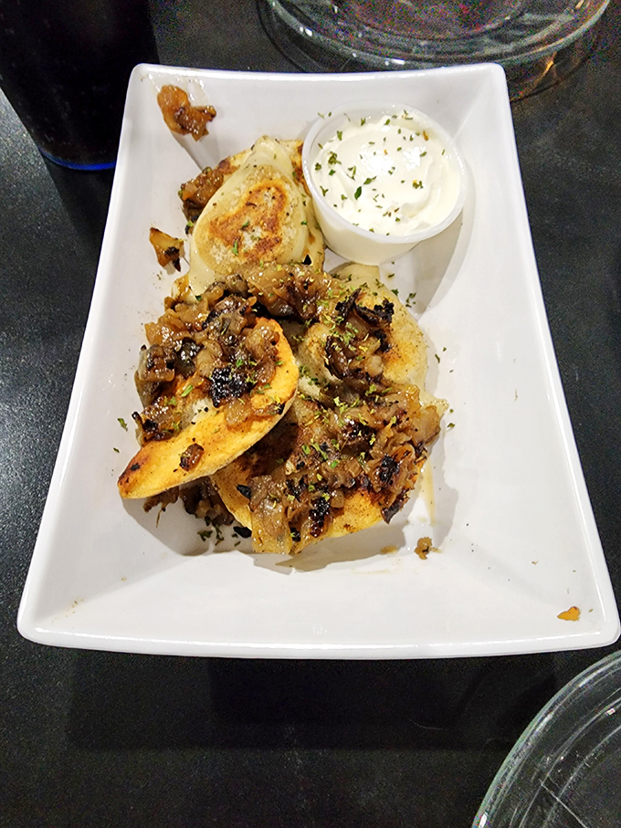 Pierogies that would make your Polish grandmother weep with joy. Golden-brown pockets of potato perfection topped with caramelized onions and a side of cool sour cream.