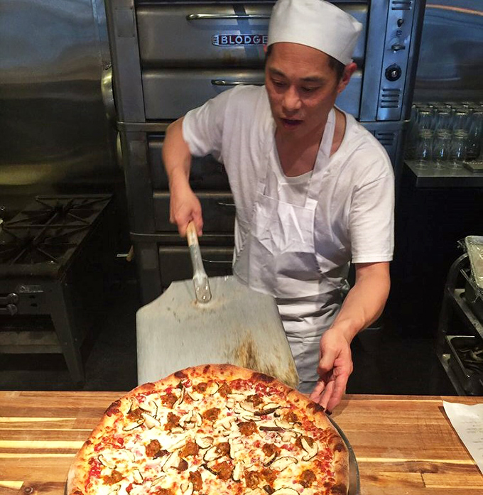 In the hands of a skilled pizza artisan, a simple wooden peel becomes a magic wand, delivering perfectly crafted pies from oven to table.