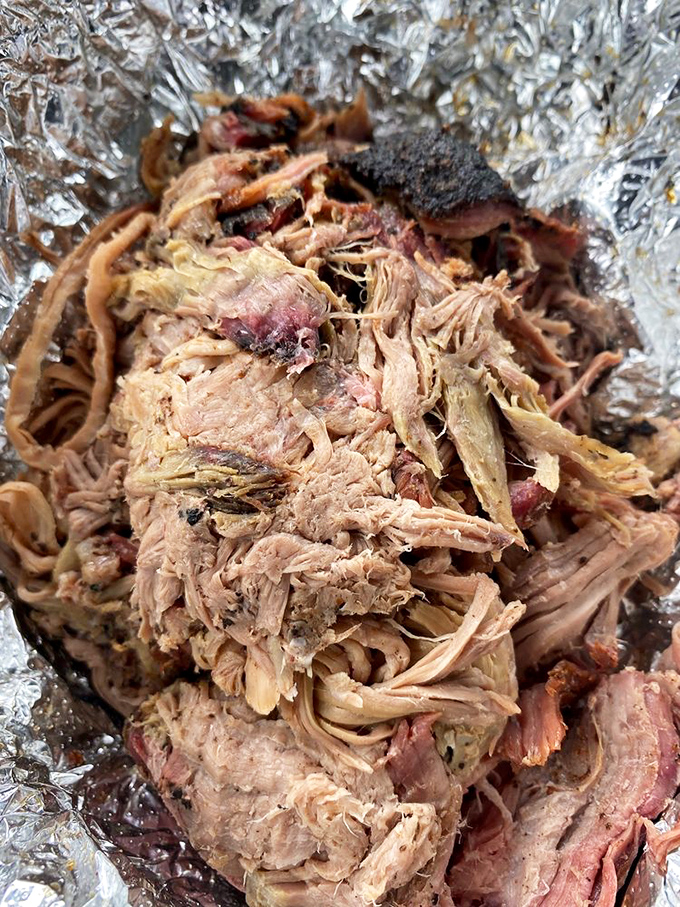Pulled pork that looks like it's been coaxed apart by angels. The bark mixed with tender strands creates a texture symphony that would make Mozart jealous.