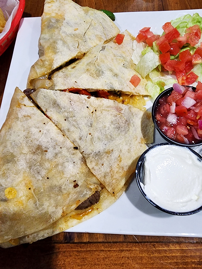 This quesadilla isn't just melted cheese between tortillas—it's a perfectly griddled pocket of joy served with fresh pico and cool sour cream.
