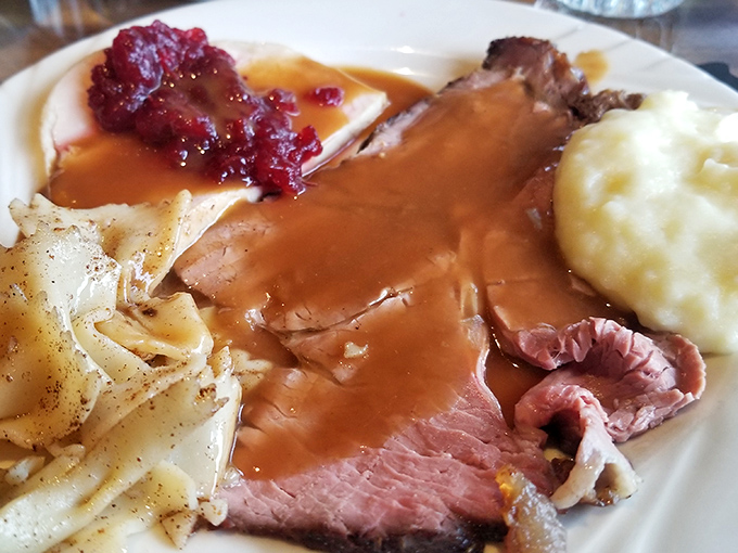 Tender roast beef swimming in rich gravy alongside creamy mashed potatoes - Sunday dinner dreams realized.