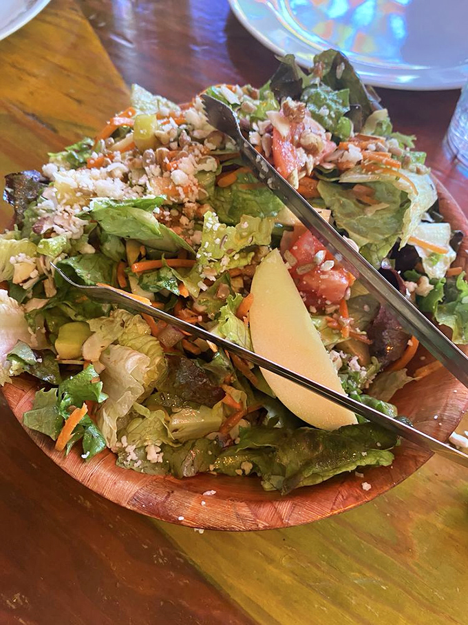 Even the salad gets the star treatment here&mdash;a wooden bowl brimming with fresh greens, nuts, and enough goodies to make vegetables feel like a celebration.