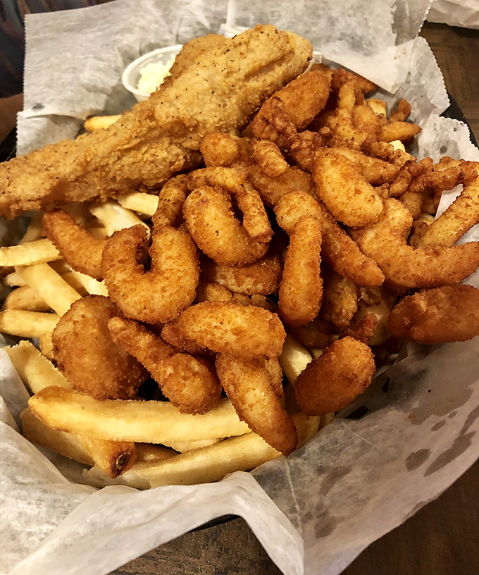 Golden-fried seafood nestled among crispy fries &ndash; a basket of oceanic treasures that makes you grateful someone figured out how to bread and fry basically anything.
