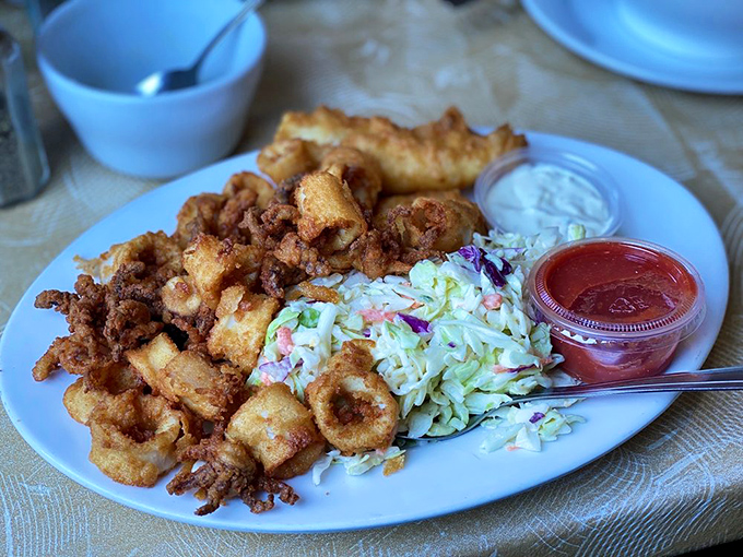 A seafood symphony arranged on a plate, where calamari and coleslaw dance in crispy harmony.