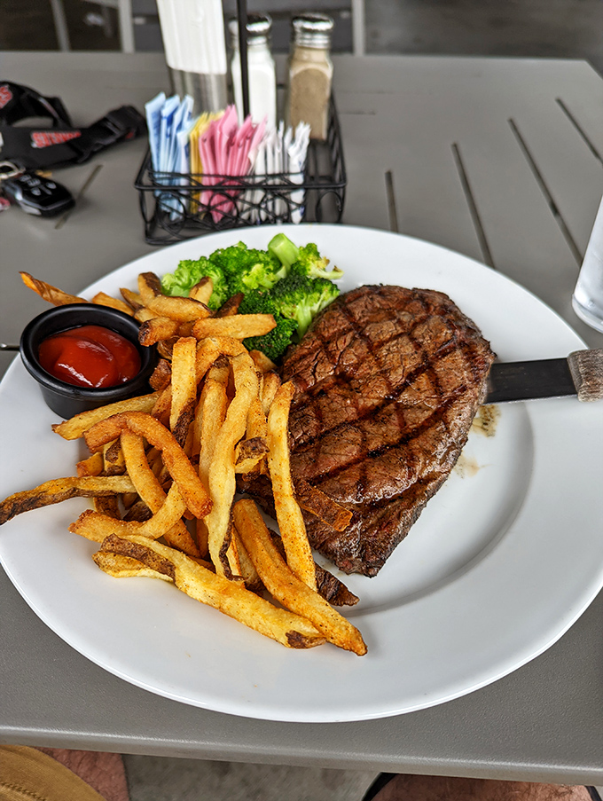 This isn't just a steak—it's a masterclass in simplicity. Perfect grill marks, golden fries, and vibrant broccoli create the holy trinity of satisfaction.