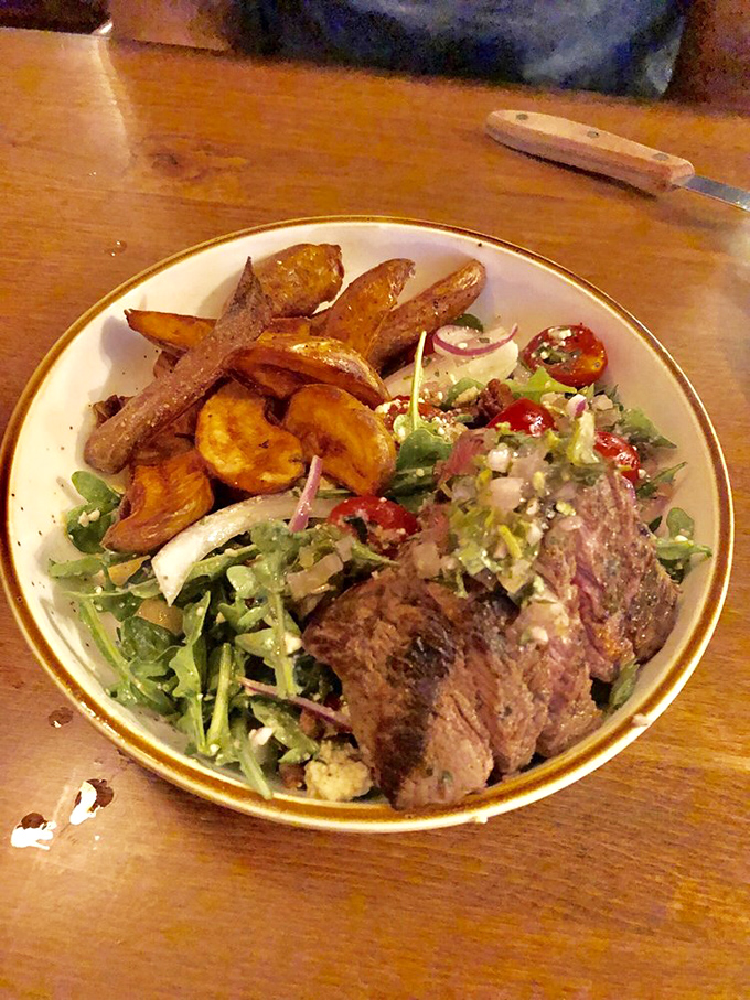 Perfectly seared steak alongside golden root vegetables&mdash;proof that simple food done right can outshine the fanciest molecular gastronomy any day.