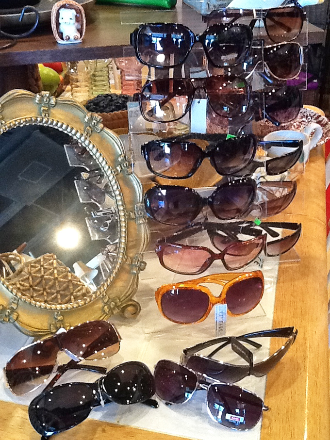 Retro shades and statement sunglasses line the display case. Fashion cycling back around makes yesterday's accessories today's must-haves.