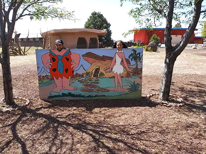 Stone Age meets pop culture in this delightful photo spot where cartoon cavemen welcome visitors to their prehistoric paradise.