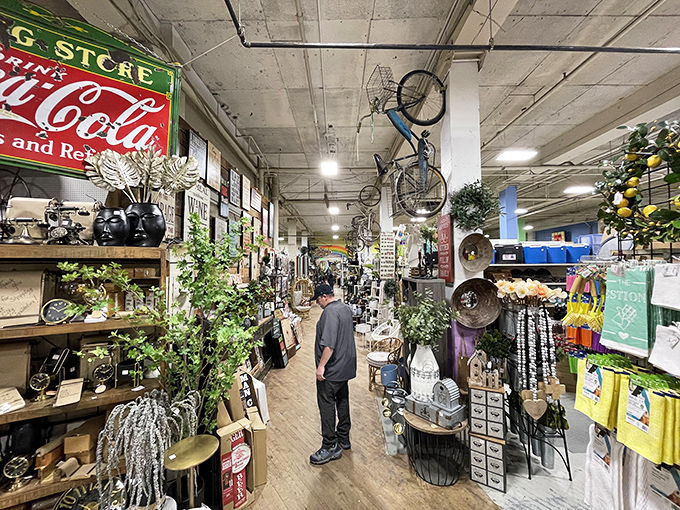 Welcome to retail archaeology, where vintage Coca-Cola signs coexist peacefully with suspended bicycles in organized beautiful chaos.