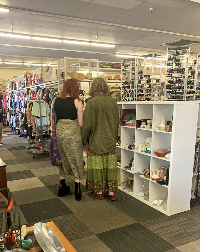 Treasure hunters browse the aisles, each on their own quest for that perfect find. The thrill of the hunt is universal in this vintage paradise.