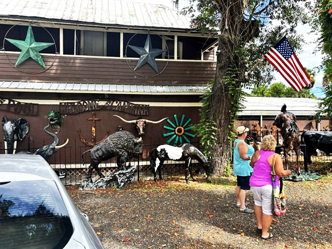 Visitors pause to admire the menagerie of metal wildlife, where buffalo and horses seem frozen mid-gallop under the watchful gaze of barn stars.