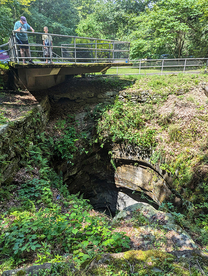 Geological sightseeing at its finest. Visitors take a moment to contemplate the immense forces of nature that created this perfectly cylindrical shaft.
