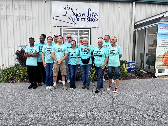The real treasures of any thrift shop: the dedicated volunteers whose "Serve Each Other" shirts perfectly capture the spirit of community.