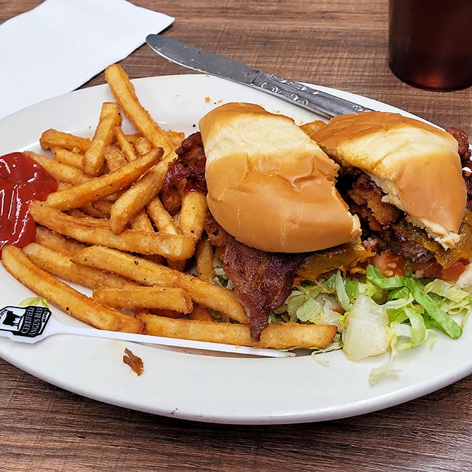 This isn't just a burger; it's architecture. Layers of flavor stacked higher than your weekend to-do list, with fries that demand equal attention.